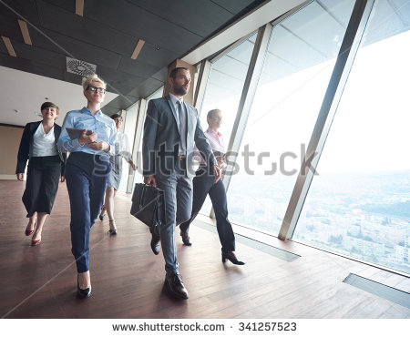 stock-photo-business-team-businesspeople-group-walking-at-modern-bright ...